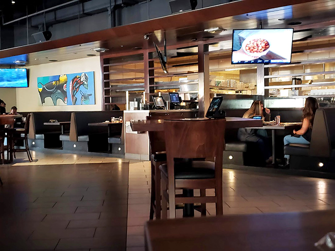 Inside, warm wood tones and contemporary art create that perfect sweet spot between "fancy night out" and "place where you can actually hear your dinner conversation."