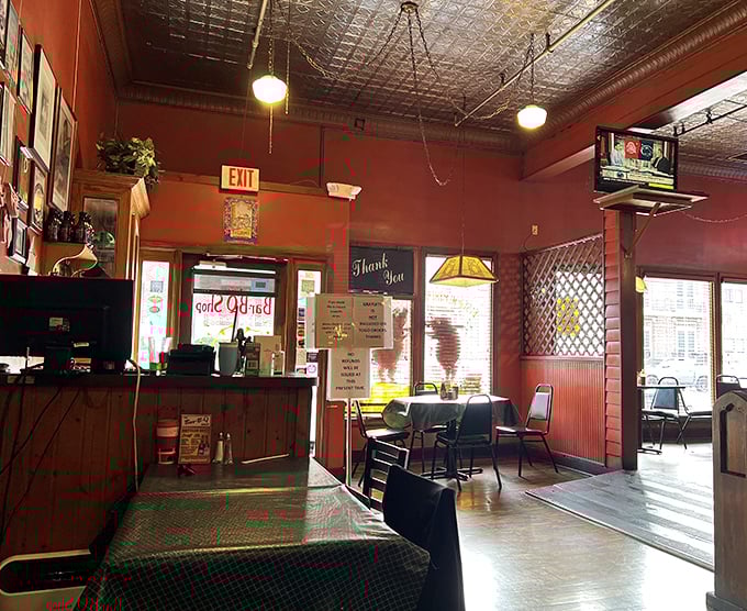 Step inside and the warm brick-red walls, vintage tin ceiling, and wooden accents immediately transport you to a Memphis where time moves at the pace of slow-smoking meat.