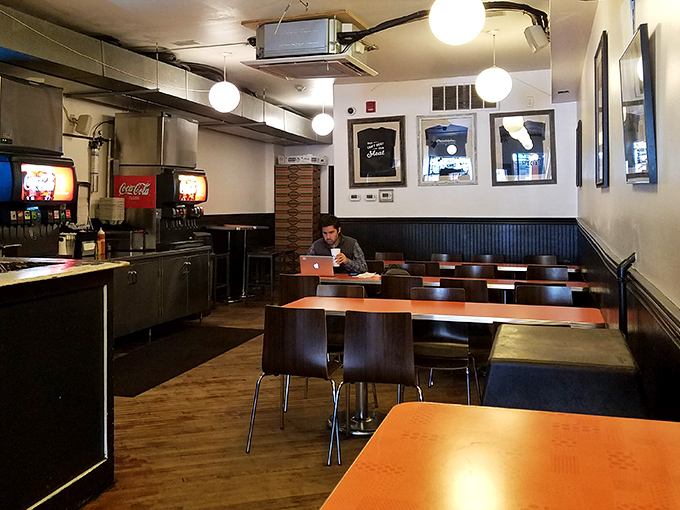 Simple wooden tables, no-nonsense lighting, and the promise of culinary bliss. This is where cheesesteak dreams come true.