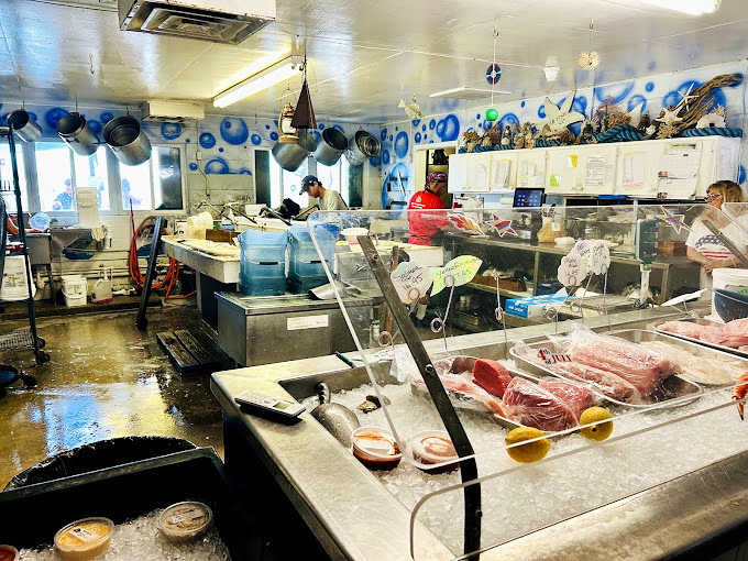Behind these glass cases lies the day's fresh catch, displayed like oceanic jewelry waiting for your selection.