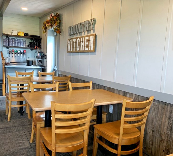 Simple wooden chairs, paneled walls, and that "KOUNTRY KITCHEN" sign tell you everything you need to know: authenticity trumps pretension here.