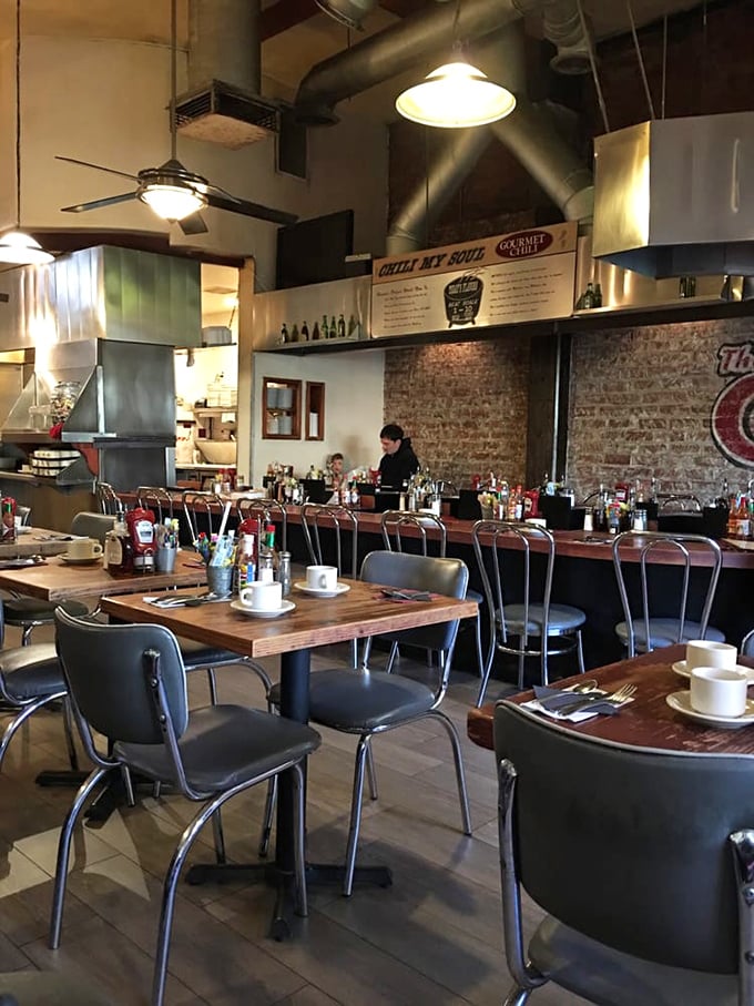 Industrial-chic meets comfort at The Griddle's interior, where exposed brick and wooden tables set the stage for breakfast theater that rivals anything on Broadway.