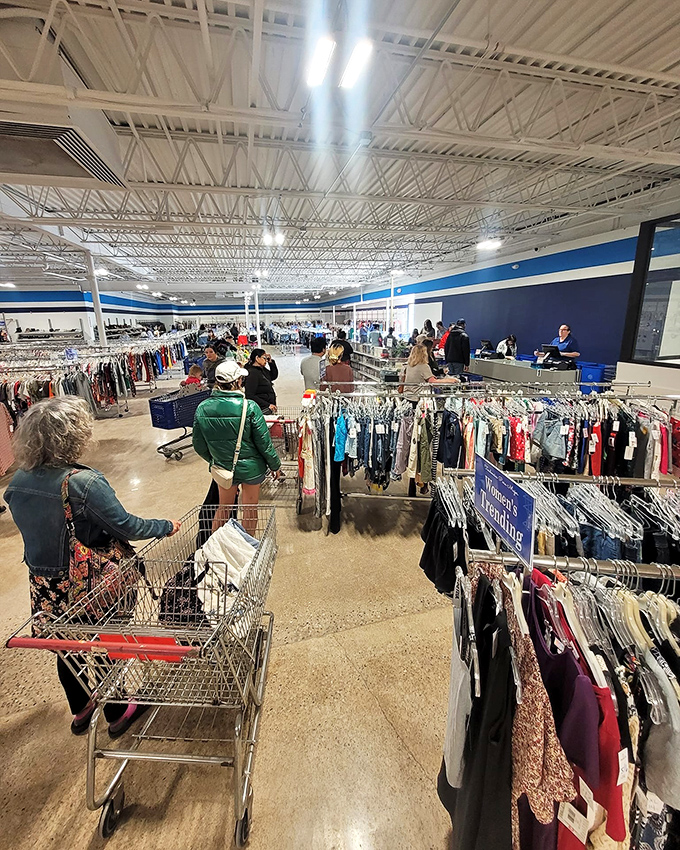 The thrill of the hunt in action. Shoppers navigate this retail wilderness with the determination of explorers seeking the legendary $5 designer jeans.