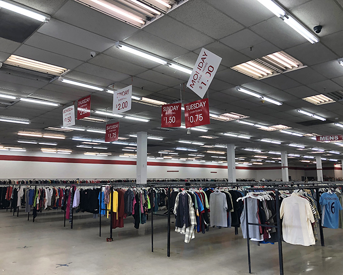 Endless racks stretch toward the horizon under those iconic red discount signs. The thrill of the hunt begins here!