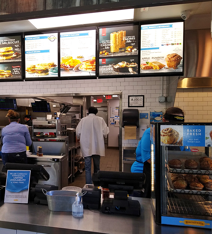 Behind the counter, the morning ballet unfolds as staff prepares fresh-baked goodness while customers eagerly await their turn at biscuit nirvana.