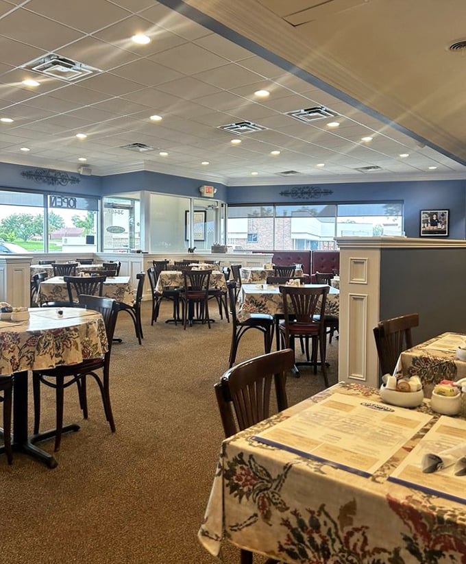 Floral tablecloths and soft blue walls create that perfect "grandma's dining room meets modern cafe" vibe. Comfort begins before the food arrives.