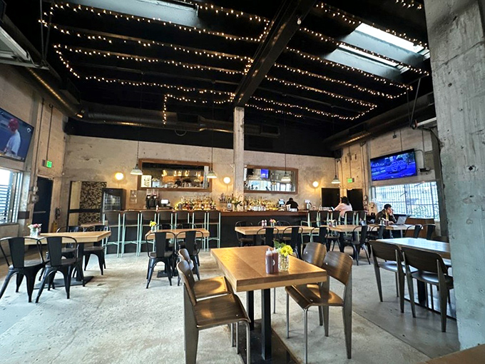 String lights dance across exposed beams, creating the perfect mood lighting for what's about to be a serious relationship between you and some smoked meat.