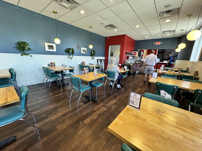 Retro turquoise chairs and blue walls create the perfect backdrop for barbecue bliss. No distractions, just you and that brisket&mdash;as it should be.