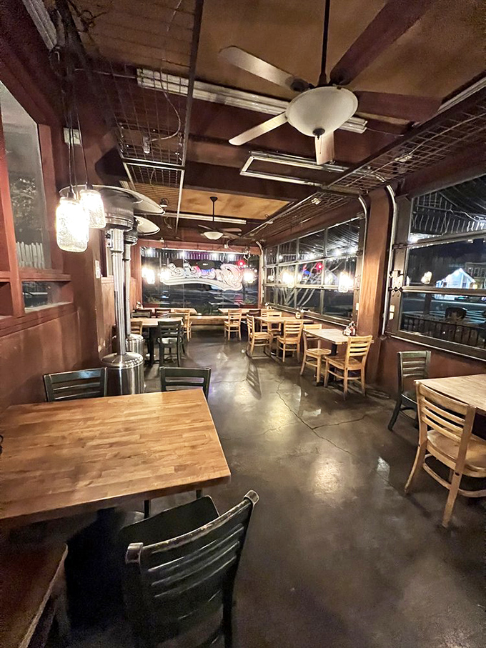 Mason jar lights cast a warm glow over wooden tables, creating that perfect "stay awhile" vibe that makes you forget you're not in someone's home.