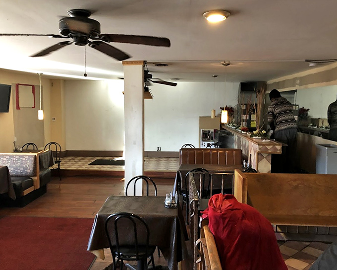 Simple tables, ceiling fans, and no-nonsense decor tell you everything you need to know: this place puts its energy where it matters&mdash;in the kitchen.