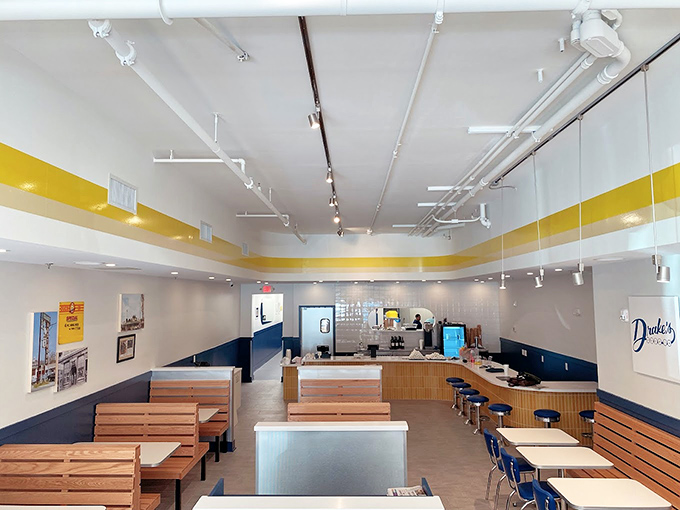 Clean lines, wooden benches, and that signature yellow stripe &ndash; Drake's interior is a masterclass in unpretentious dining where the food, not the decor, takes center stage.