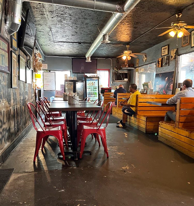 Red chairs against weathered walls tell stories of countless BBQ pilgrimages. The patina here isn't decoration &ndash; it's history.
