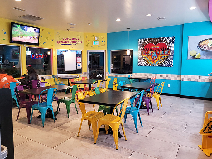 A kaleidoscope of colorful chairs welcomes diners into a vibrant space where serious taco business happens daily.