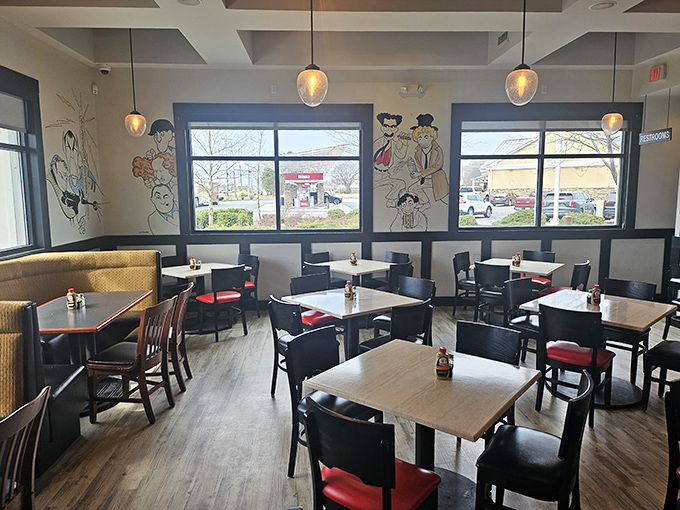 Inside, caricature-adorned walls and warm pendant lighting create the perfect backdrop for the sandwich symphony about to unfold at your table.