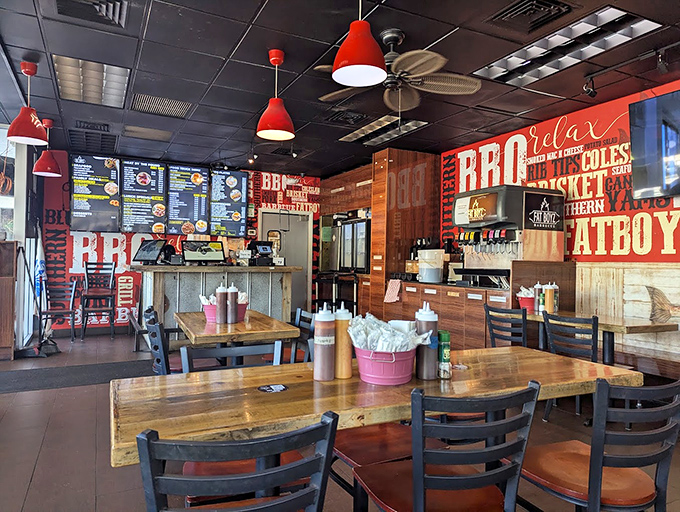 Inside, rustic wooden tables and red pendant lights create the perfect stage for the smoky drama about to unfold on your plate.