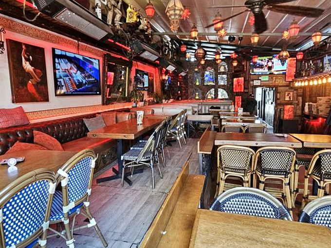The Spanish-style façade whispers "vacation" even on a Tuesday lunch break. Red umbrellas stand ready for those rare moments when California sunshine needs tempering.