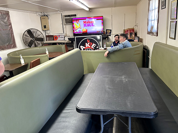 No white tablecloths needed. These green vinyl booths have witnessed more culinary joy than most five-star restaurants ever will.