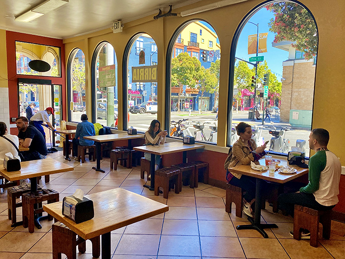 Sunlight streams through those magnificent arched windows, turning an ordinary lunch into a stained-glass cathedral of burrito worship.