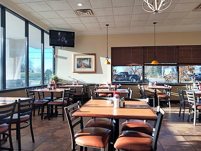 Sunlight streams through large windows, illuminating wooden tables where breakfast dreams come true. The stage is set for pancake perfection.