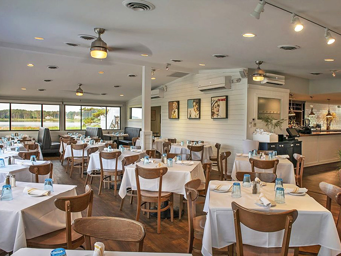 Crisp white tablecloths meet warm wooden accents in this airy dining room, where water views complement every bite of oceanic bliss.