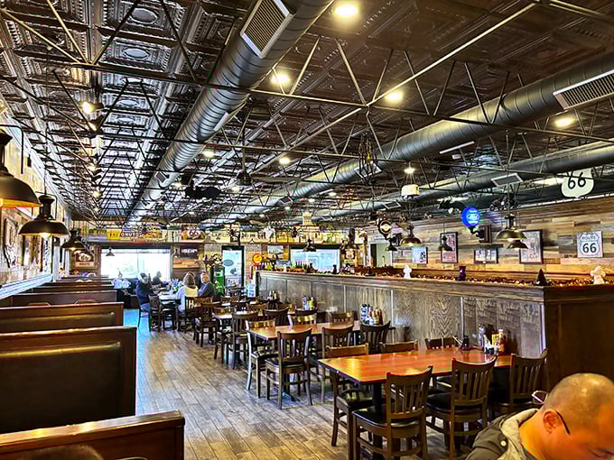 Exposed ductwork meets wooden booths in this temple to road trip nostalgia. The perfect backdrop for conversations that meander like the Mother Road itself.