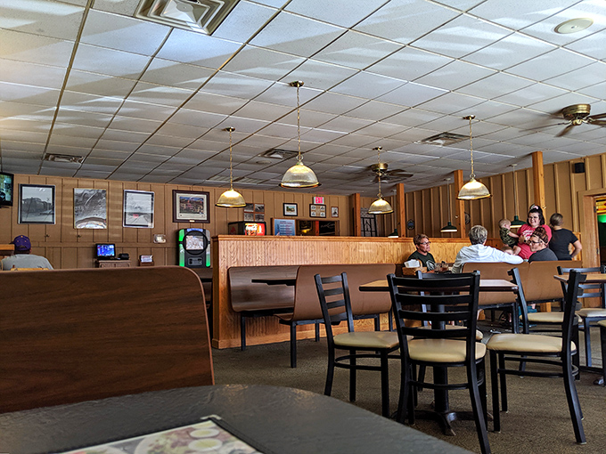 Wood-paneled walls and pendant lighting create that perfect small-town pizza joint ambiance – where everybody might not know your name yet, but they'll remember your order.