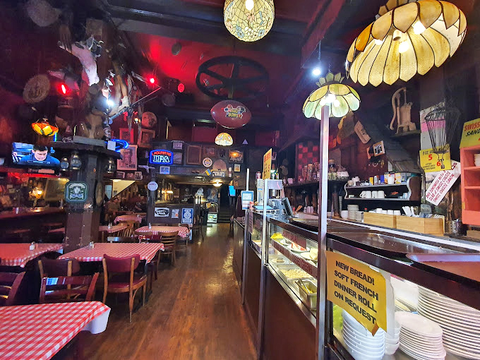 Step inside and time stands still&mdash;vintage lamps cast a warm glow over red-checkered tablecloths while decades of collected memorabilia tell stories from every wall.