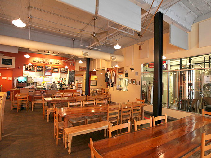 Wooden communal tables and exposed ceiling ducts create that perfect "industrial chic meets neighborhood joint" vibe where conversations flow as freely as the beer.