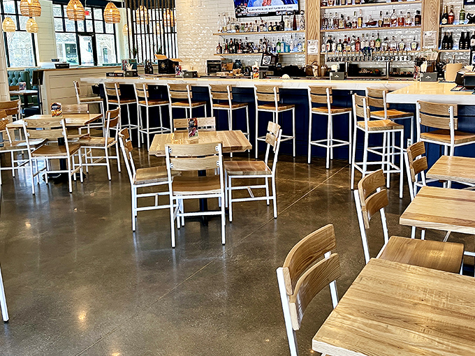 Modern coastal chic meets Georgia hospitality in this thoughtfully designed interior. Light wood tables and white metal chairs create an airy atmosphere that's both upscale and approachable.