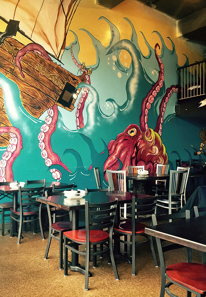 Dining under the watchful eye of a giant octopus mural feels like being in an underwater fantasy. The vibrant art transforms a simple meal into an oceanic adventure.