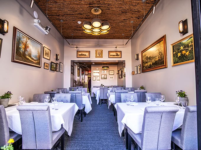 Elegance meets comfort in Elwood's dining room, where landscape paintings and a textured ceiling create the perfect backdrop for Pennsylvania-inspired cuisine.