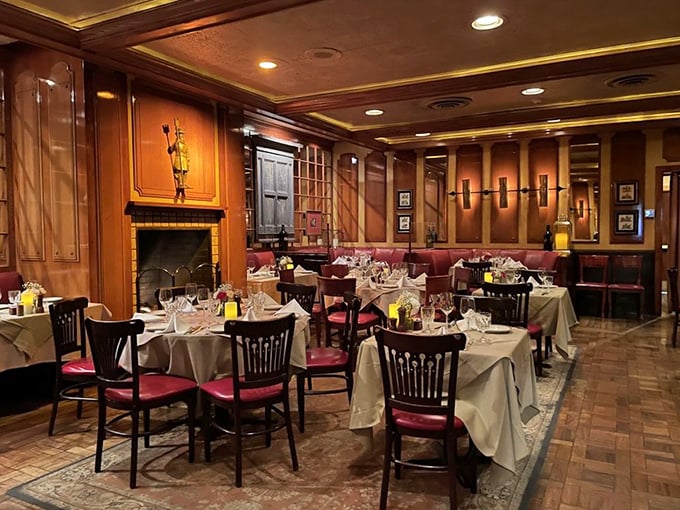 Wood-paneled warmth meets old-school elegance in this dining room where time stands deliciously still. The crackling fireplace practically whispers, "Stay awhile."