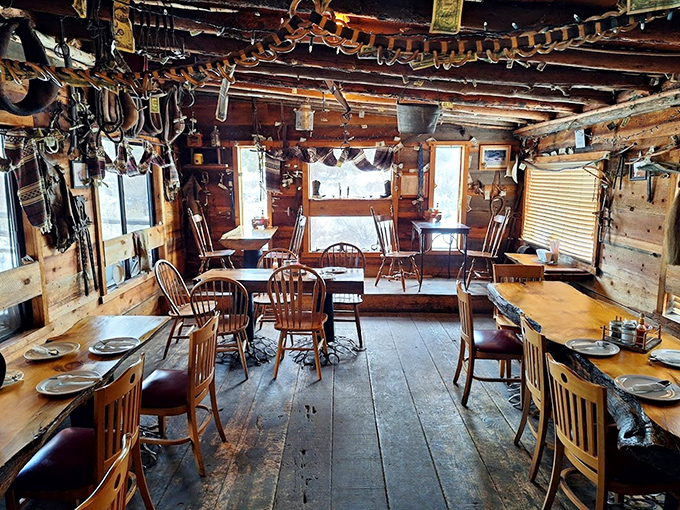 Inside, cowboy artifacts dangle from rough-hewn beams while simple wooden tables await their next feast. This isn't d&eacute;cor&mdash;it's genuine frontier heritage.