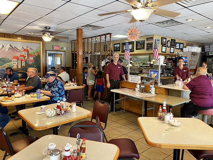 Inside Ray's, time slows down as ceiling fans lazily spin above burgundy booths where regulars solve the world's problems over coffee and those legendary hash browns.