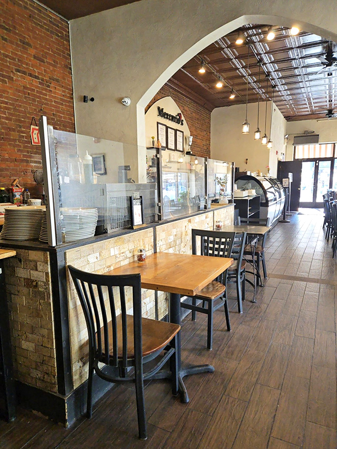 Inside, exposed brick walls and warm lighting create that perfect "come stay awhile" atmosphere where pizza dreams and gelato fantasies harmoniously coexist.