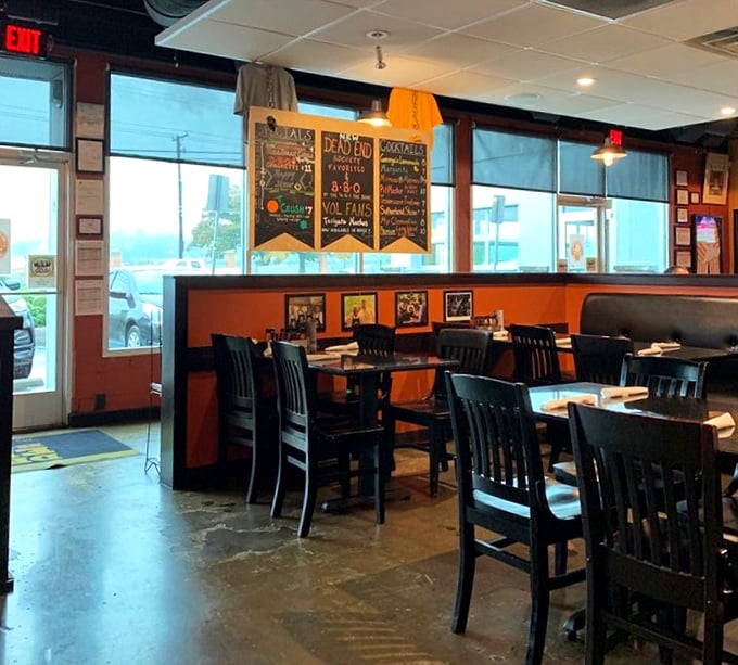 Orange walls and competition banners tell you immediately: this isn't just dinner, it's a pilgrimage to the promised land of proper Tennessee barbecue.