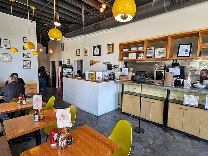 Bright yellow pendant lights hang like buttery beacons of hope, guiding hungry pilgrims to their flaky, golden salvation.