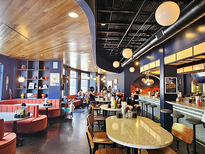 Mid-century meets modern in this space-age diner interior where coral booths invite you to settle in for the long, delicious haul.