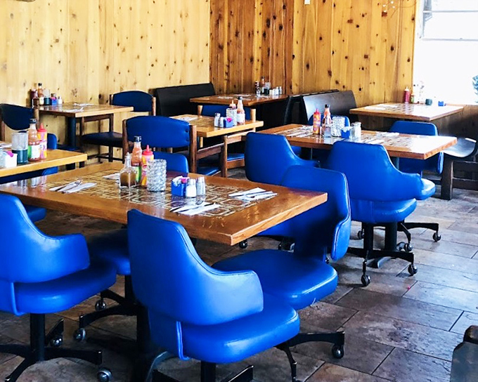 Blue chairs and pine-paneled walls create the perfect no-frills backdrop for serious barbecue consumption. Comfort trumps pretension every time.