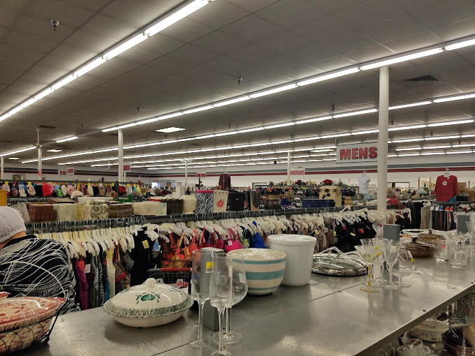 Glassware gleams under fluorescent lights while clothing racks stretch to the horizon. It's the Narnia of secondhand shopping.