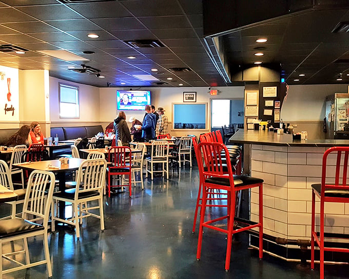 Inside, the vibrant red bar stools pop against the clean interior, creating that perfect "everybody knows your name" neighborhood vibe.