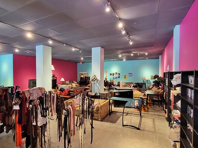 Vibrant pink and turquoise walls create distinct shopping zones while furniture displays invite you to imagine these pieces in your own home. Thrifting paradise, organized.