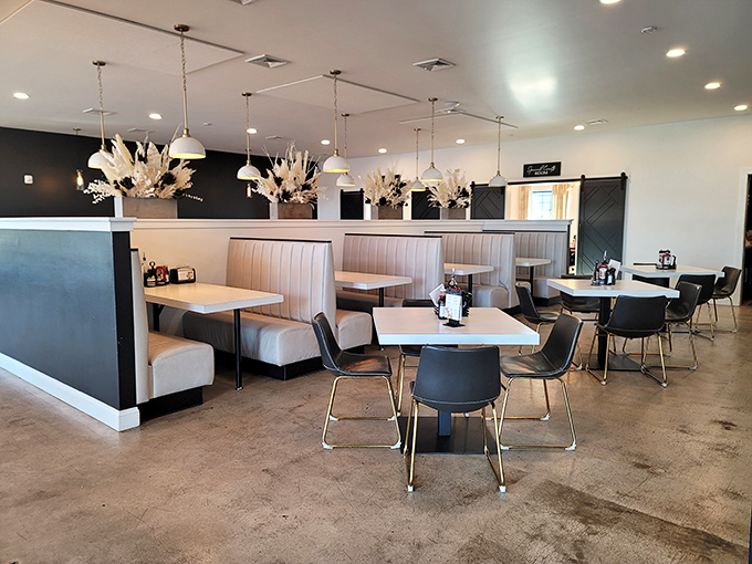 Modern farmhouse chic meets comfort in this thoughtfully designed space. Cream booths, black accents, and dried floral arrangements create an atmosphere that's both stylish and welcoming.