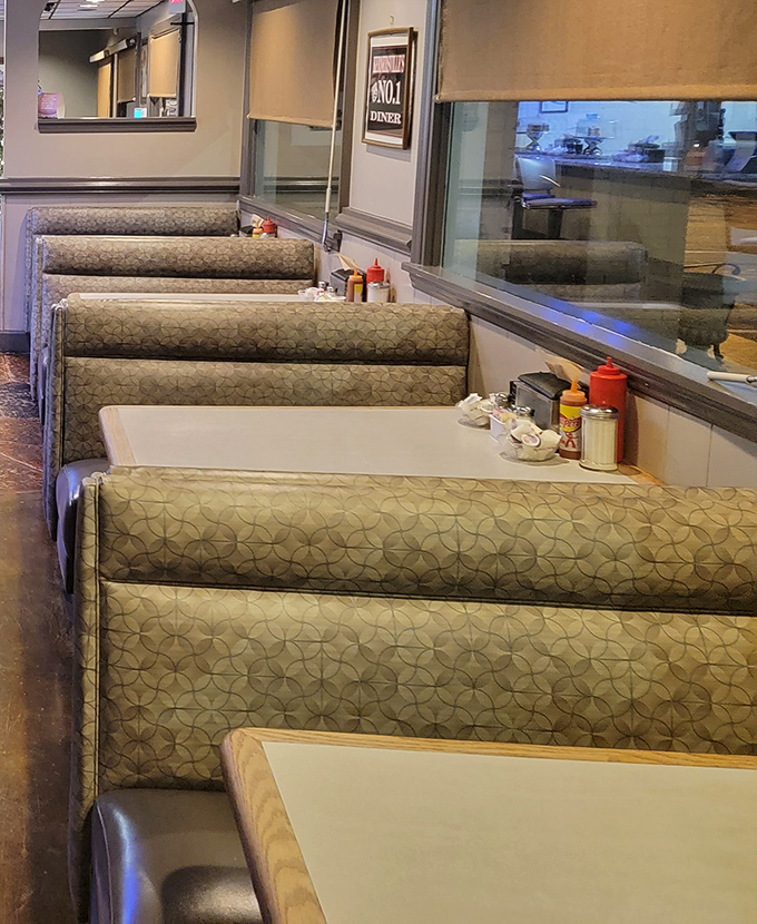 Classic booth seating with that perfect vinyl give &ndash; where conversations flow as freely as the coffee refills.