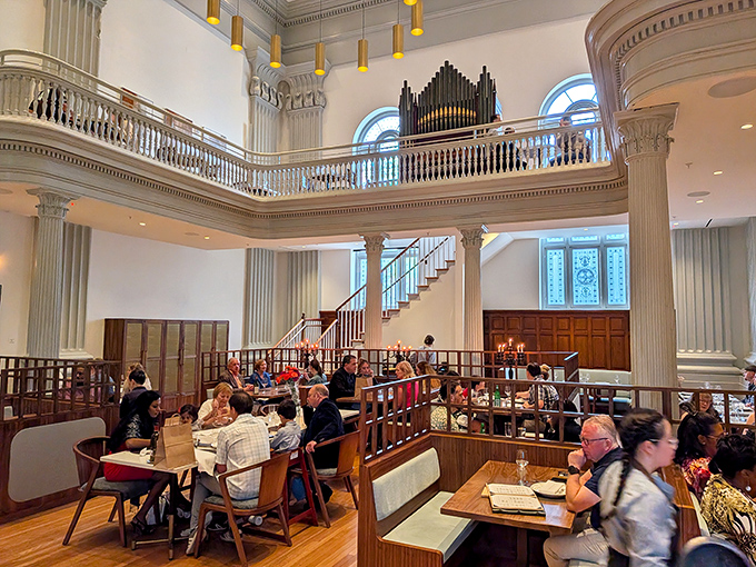 Cathedral ceilings meet culinary excellence where former pews have been replaced by tables of devoted diners.