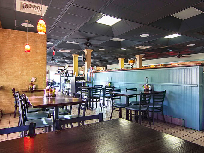 Light blue wainscoting meets warm pendant lighting in this cozy interior where comfort food dreams come true. Like a Southern living room, but with better cooking.