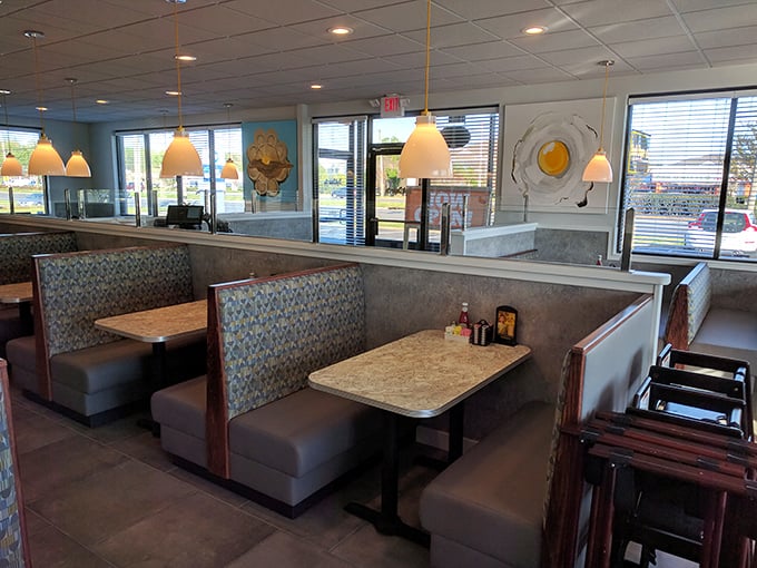 Classic diner comfort meets modern design in these cozy booths. That egg-shaped wall art? A cheeky nod to breakfast's starring role.