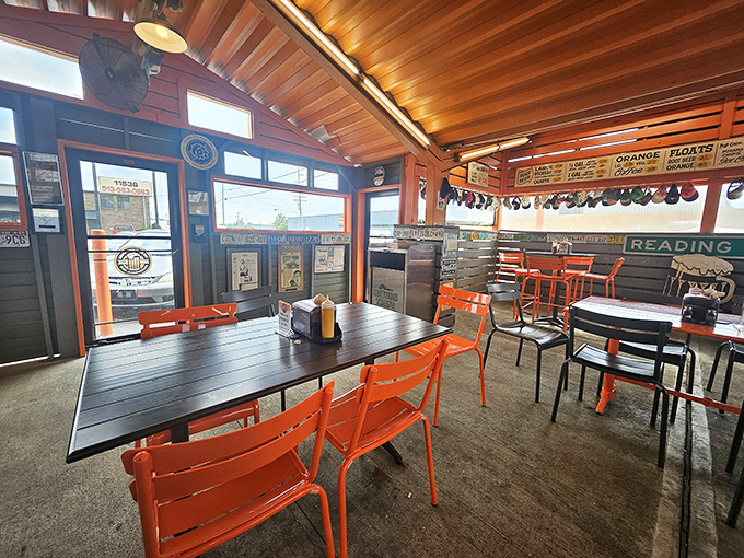 Orange chairs and covered seating create the perfect storm of comfort and nostalgia under that gorgeous wooden ceiling.