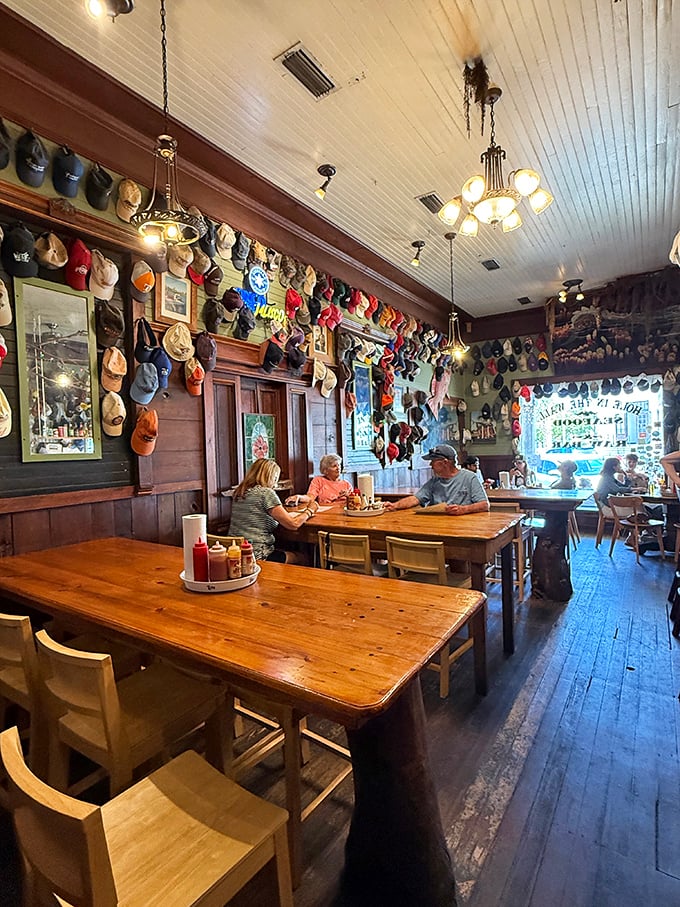 Baseball caps line the walls like trophies of adventures past, while wooden tables bear the honorable scars of countless seafood feasts. This isn't d&eacute;cor&mdash;it's a visual guestbook.