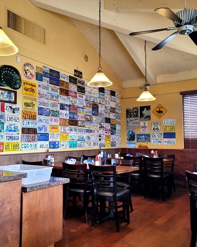 License plates from across America create a colorful mosaic on the walls, telling stories of road trips while you create your own breakfast memories.